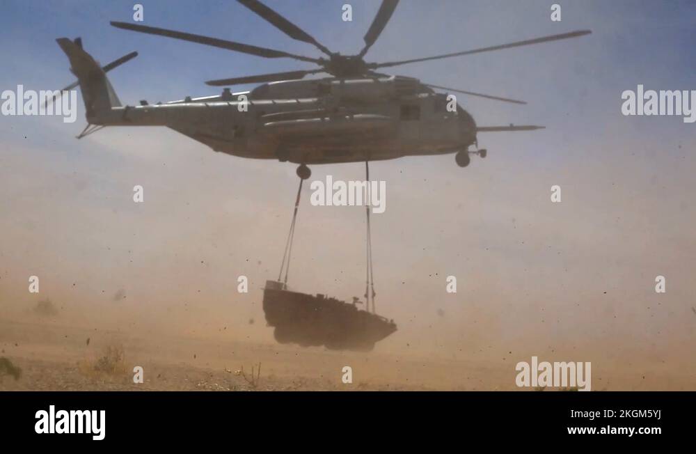 CH-53 Super Stallion creates sand storm while lifting armored vehicle ...