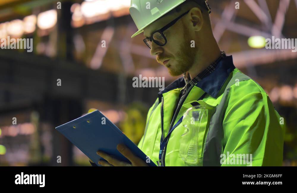 Attentive factory worker writing Stock Videos & Footage - HD and 4K ...