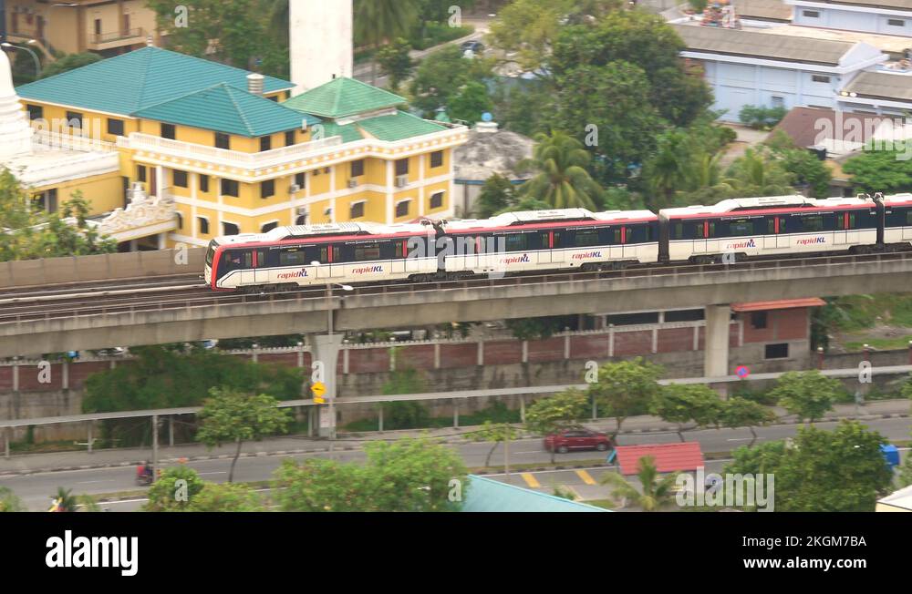 Panning view of Light Rapid Transit (LRT) train at sub-urban Kuala ...