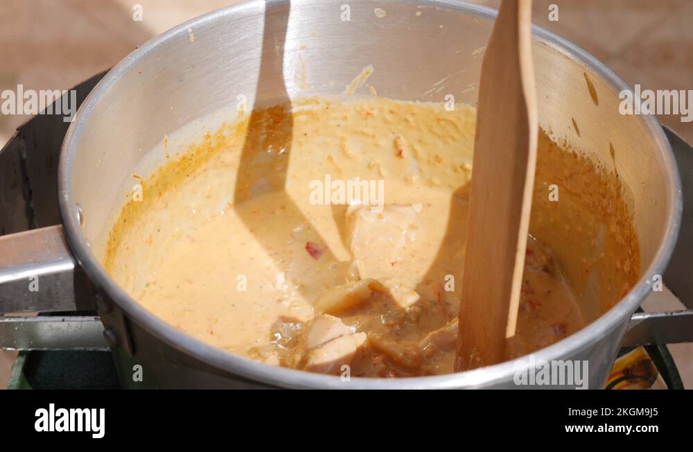 Step by step cooking tom yam soup. Chicken fillet added to boiling ...