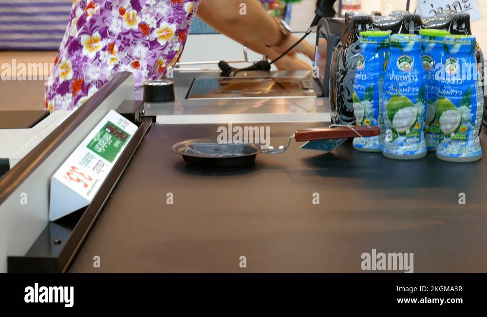 At the Supermarket: Checkout Counter Hands of the cashier scanning ...