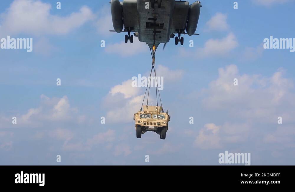 Sikorsky CH-53E Super Stallion airlifting a humvee Stock Video Footage ...