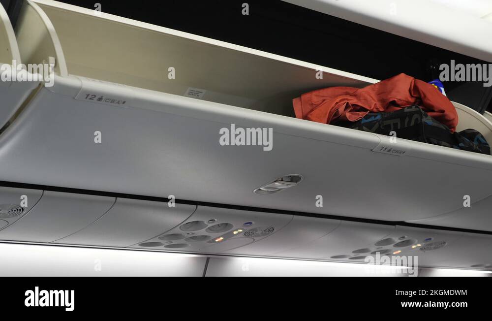 Overhead storage compartment in airplane Stock Videos & Footage - HD ...