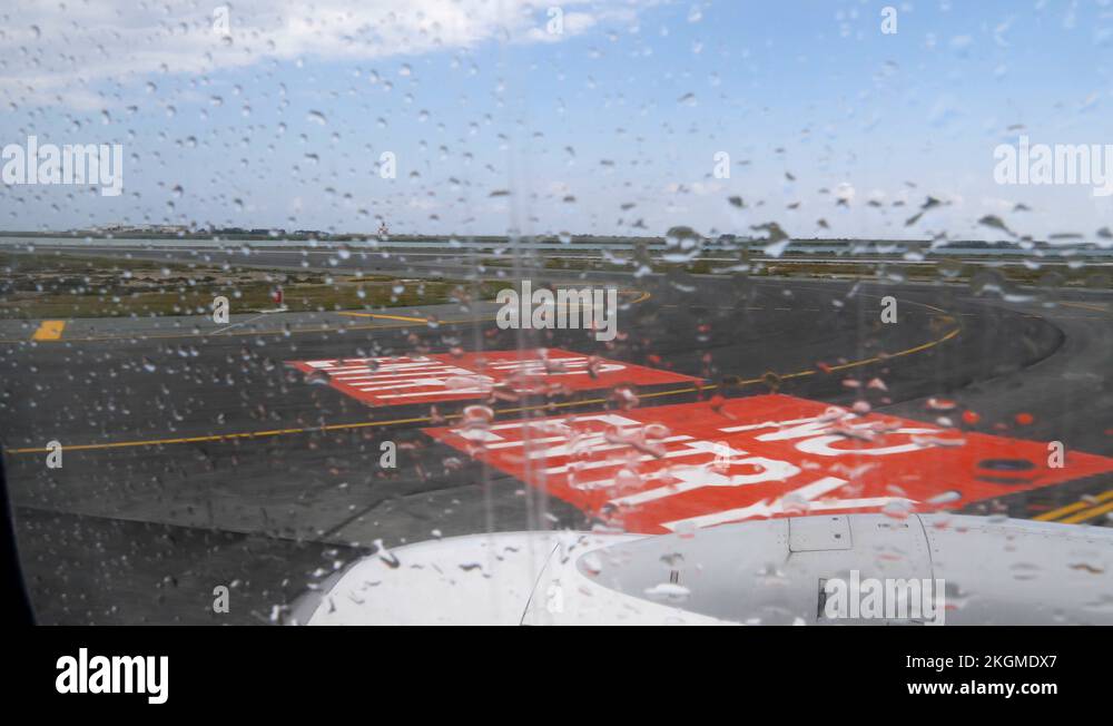 Airport runway view sign no entry through moving plane window before ...