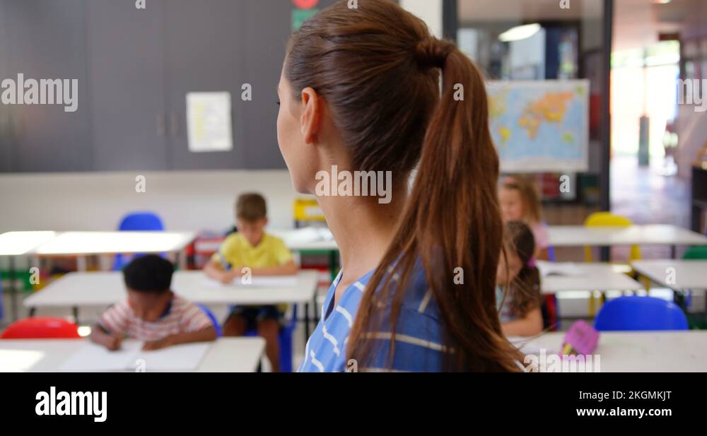 Side view of Caucasian female teacher smiling in the classroom 4k Stock ...