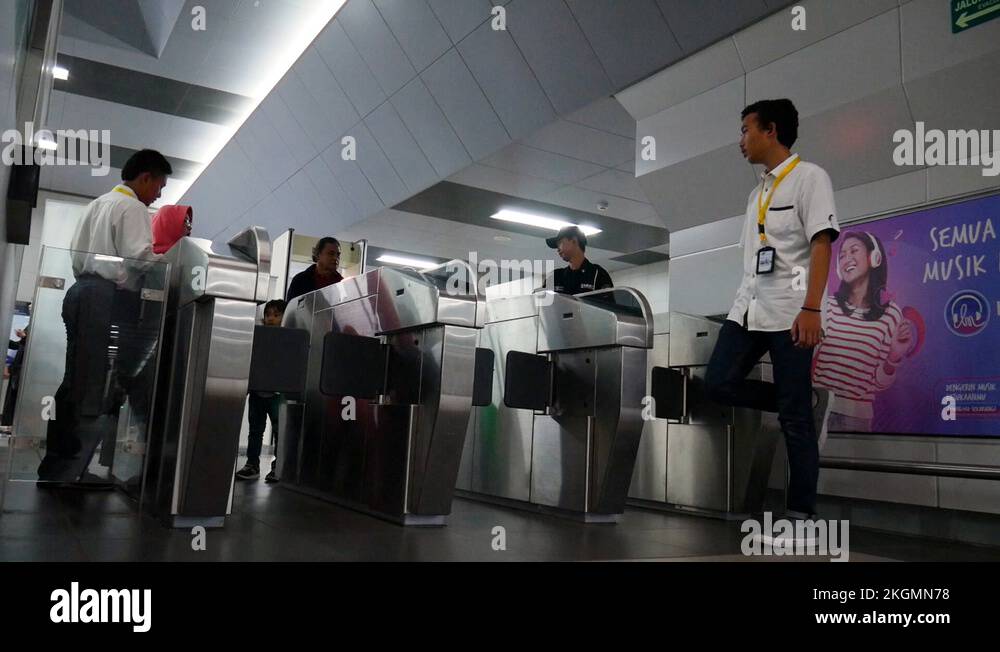 Jakarta MRT - People Entering MRT Gate Helped by officers Stock Video ...