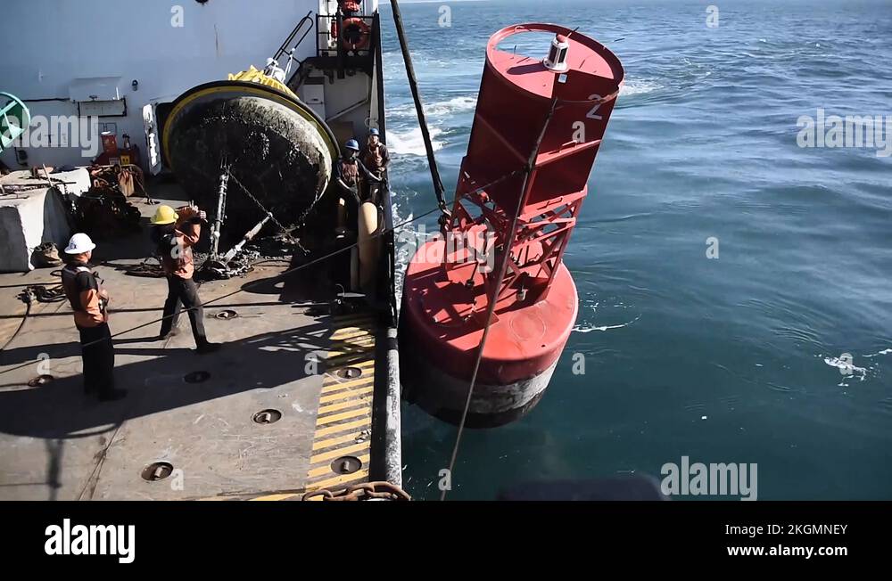 Crew aboard Coast Guard Cutter Aspen lowering new navigational buoy into sea Stock Video Footage ...