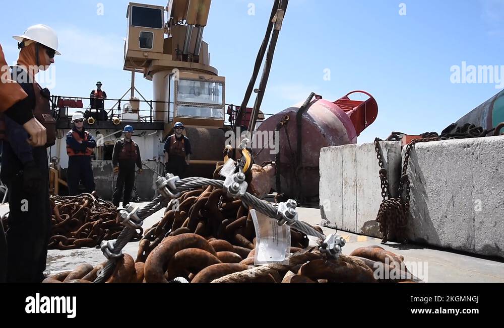 Crane lifting metal chains aboard U.S. Coast Guard Cutter Aspen Stock ...