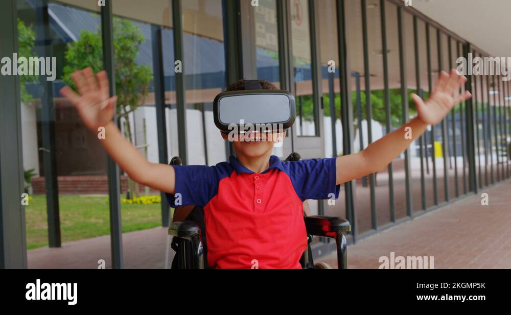 Front view of disabled African American schoolboy using virtual reality ...