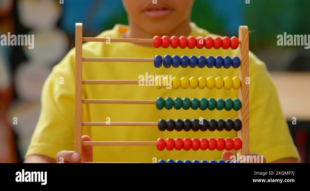 Mid section of African American schoolboy using abacus in classroom at ...