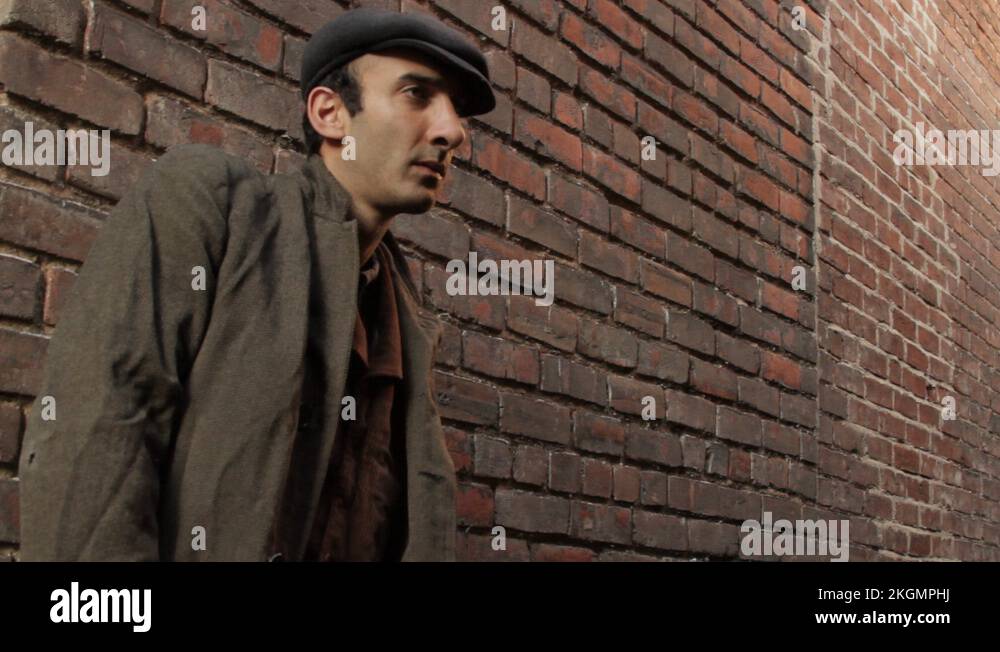 Portrayal of Gangster/Mobsters standing against a brick wall with ...