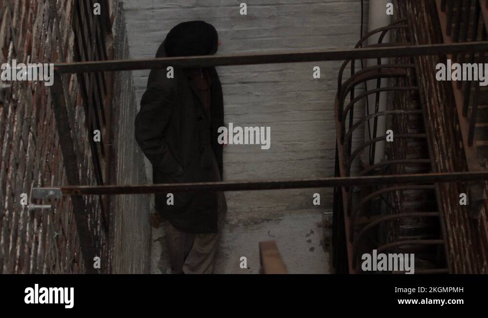 Portrayal of Gangster/Mobster waiting for a meeting in a back-alley ...