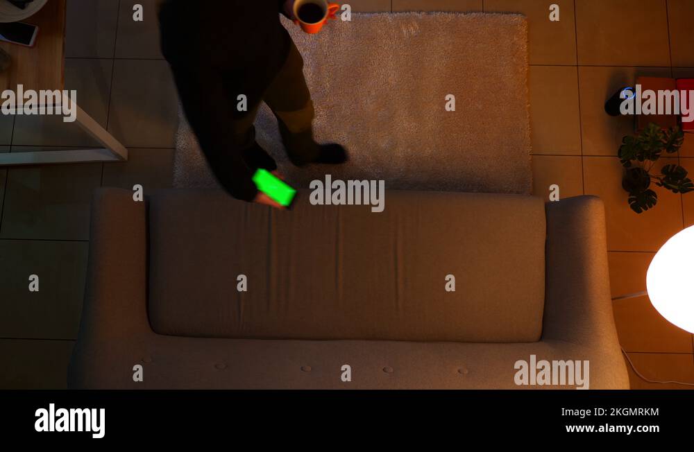 Closeup top shoot of pretty female watching TV using the phone with ...