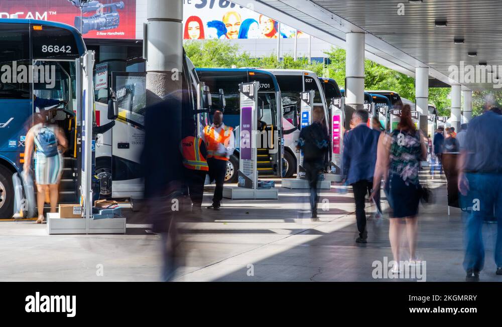 People arriving and departing at busy fast moving metro bus station ...