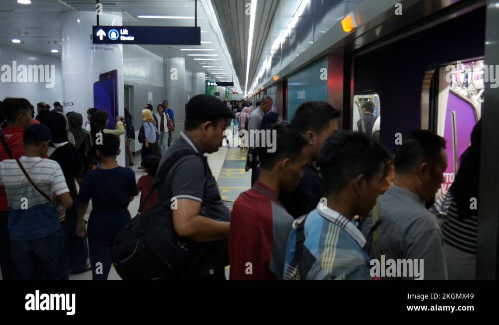Jakarta MRT - passengers queued and entered the commuter Stock Video ...