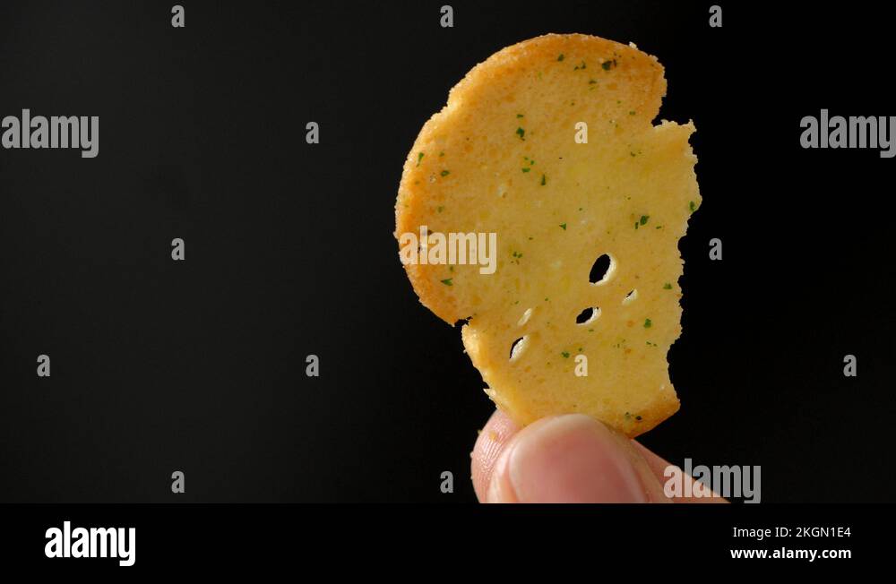 Beer snack salthy spiced cracker in extreme close up black background ...