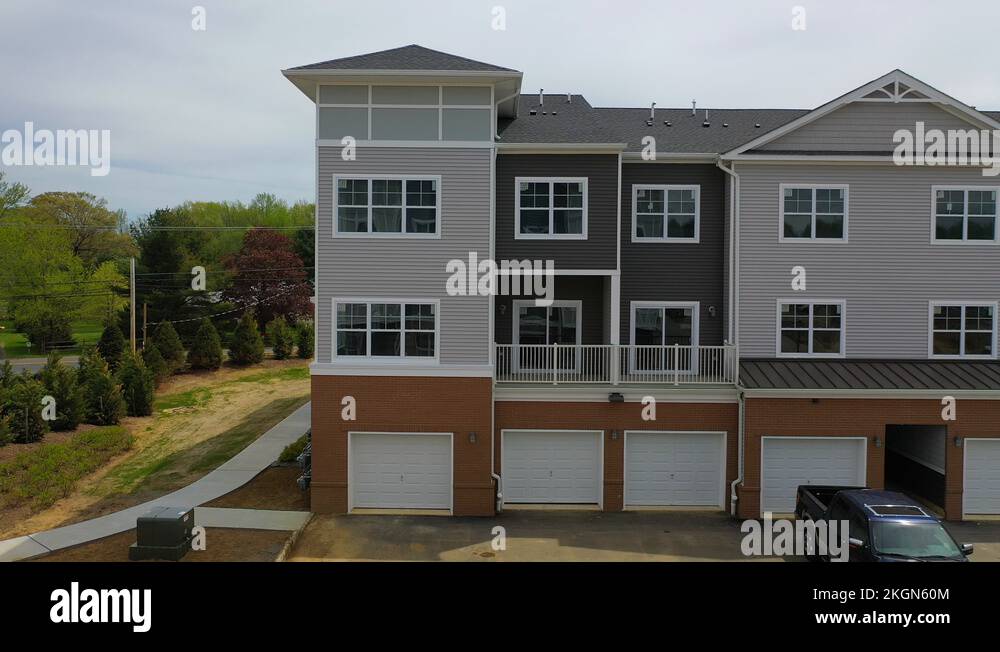 Slider Shot Right of Luxury Apartment Complex and the Indoor Car Garage ...