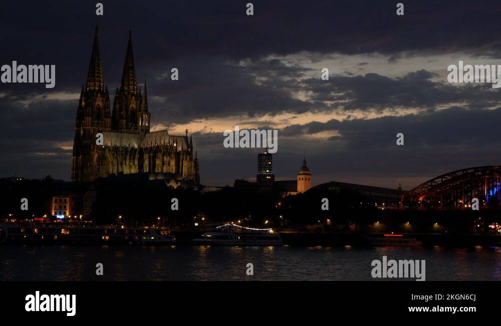 Cologne Cathedral with train on the Hohenzollern Bridge Sunset Stock ...