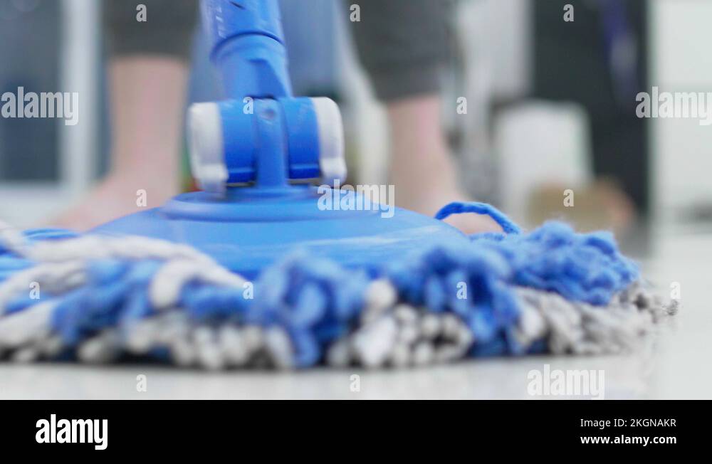 Close up Asian young boy help family cleaning the house using a mop ...