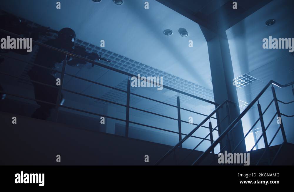 Masked Squad of Armed SWAT Police Officers Move in Formation on a ...