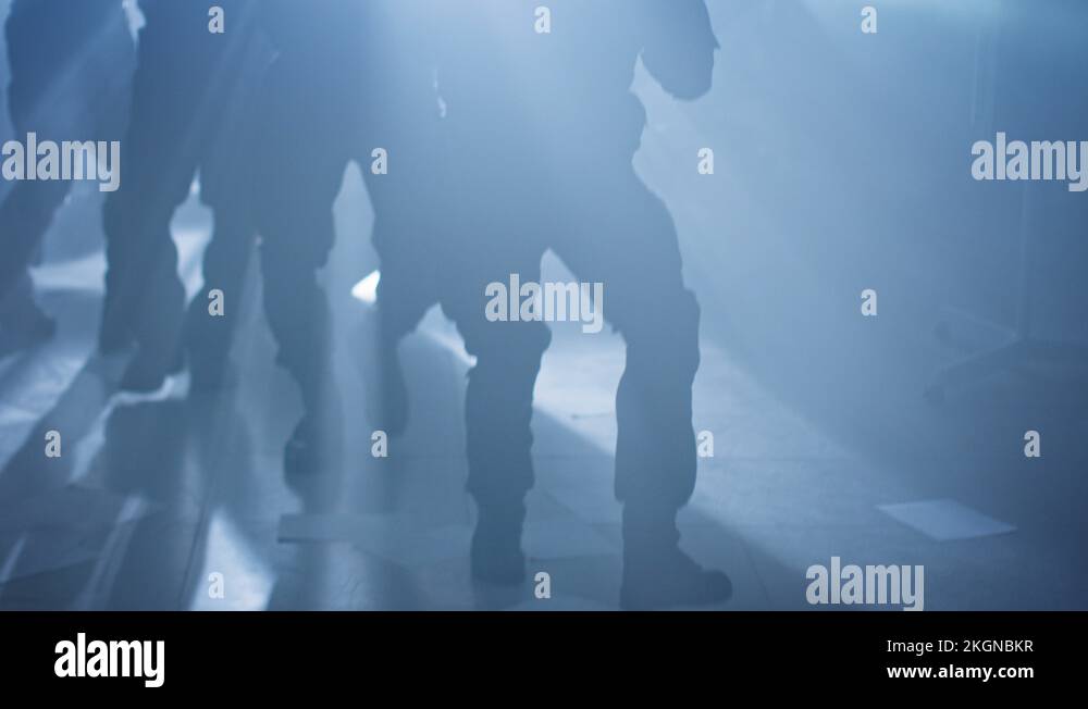 Masked Team of Armed SWAT Police Officers Slowly Move in a Hall of a ...