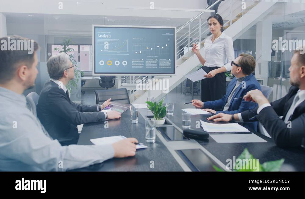 In the Corporate Meeting Room Female Analyst Uses Digital Interactive ...
