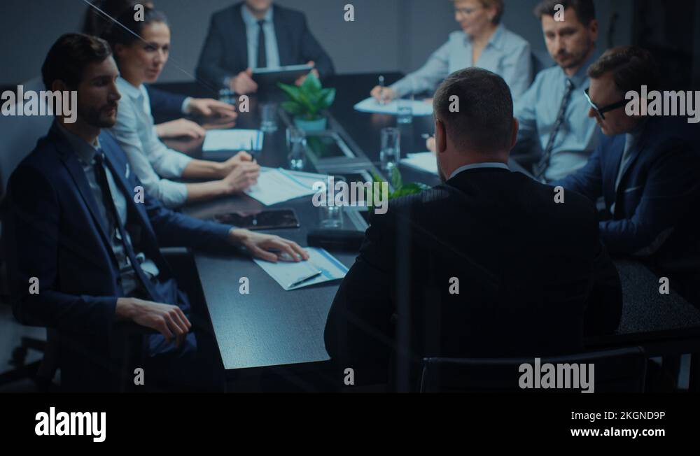 Late at Night In the Corporate Office Meeting Room: At Conference Table ...