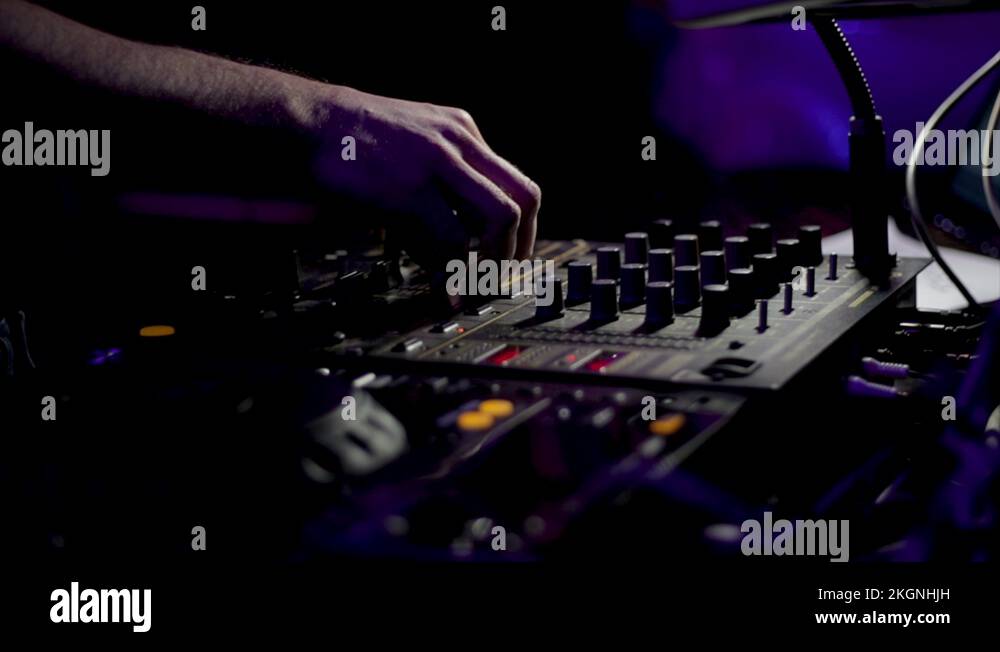 Club DJ close up hands using mixing board to spin music. Audio ...