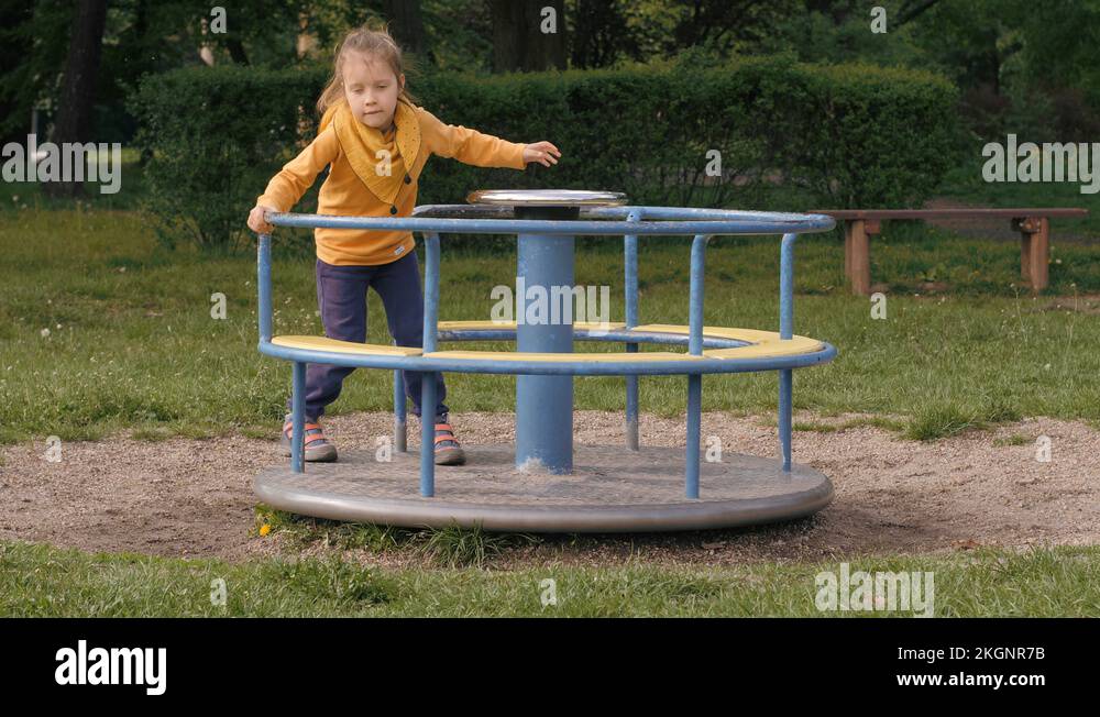 Funny little kid girl play in a park playground fail falling during ...