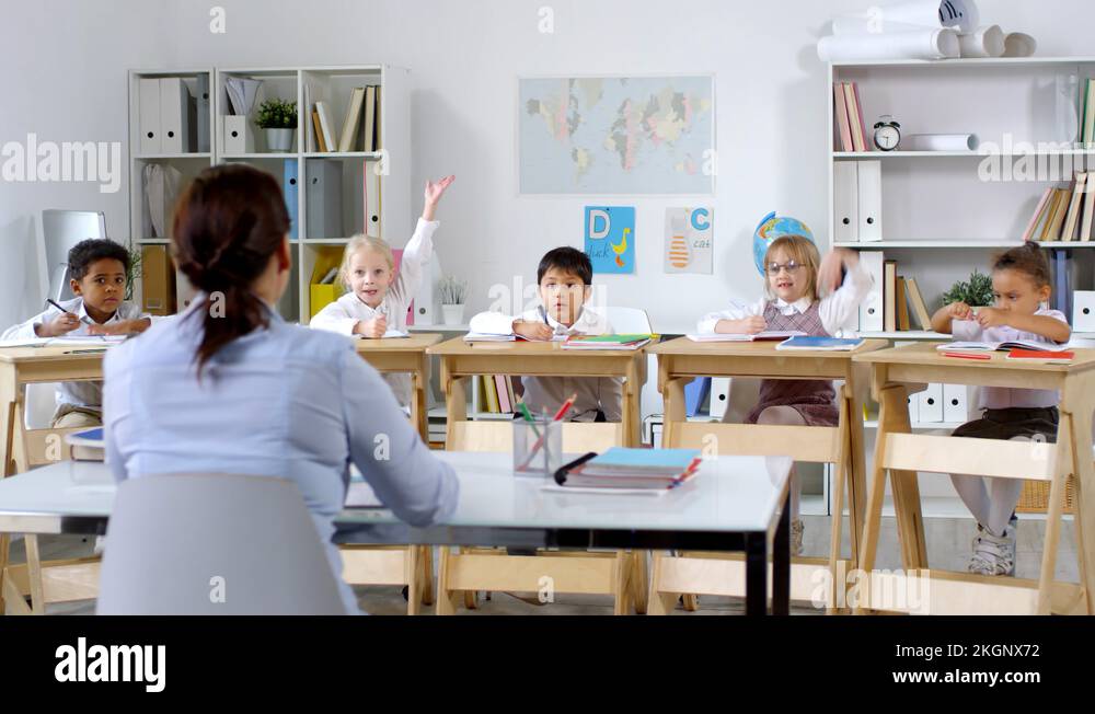 Primary Age Schoolchildren Raising Hands in Class Stock Video Footage ...