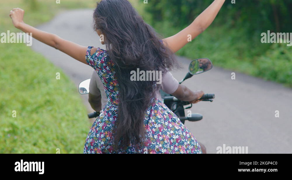 Indian man and woman on a motorcycle ride along the rice field Stock ...