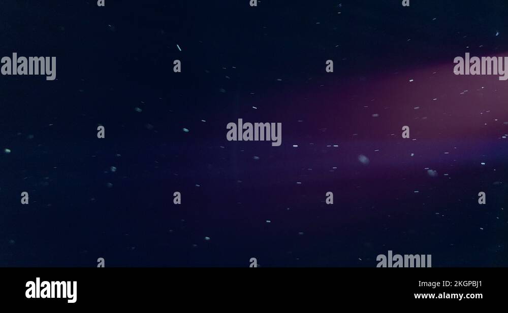 Specks Of Dust Floating A Beam Of Light Stock Video Footage - Alamy