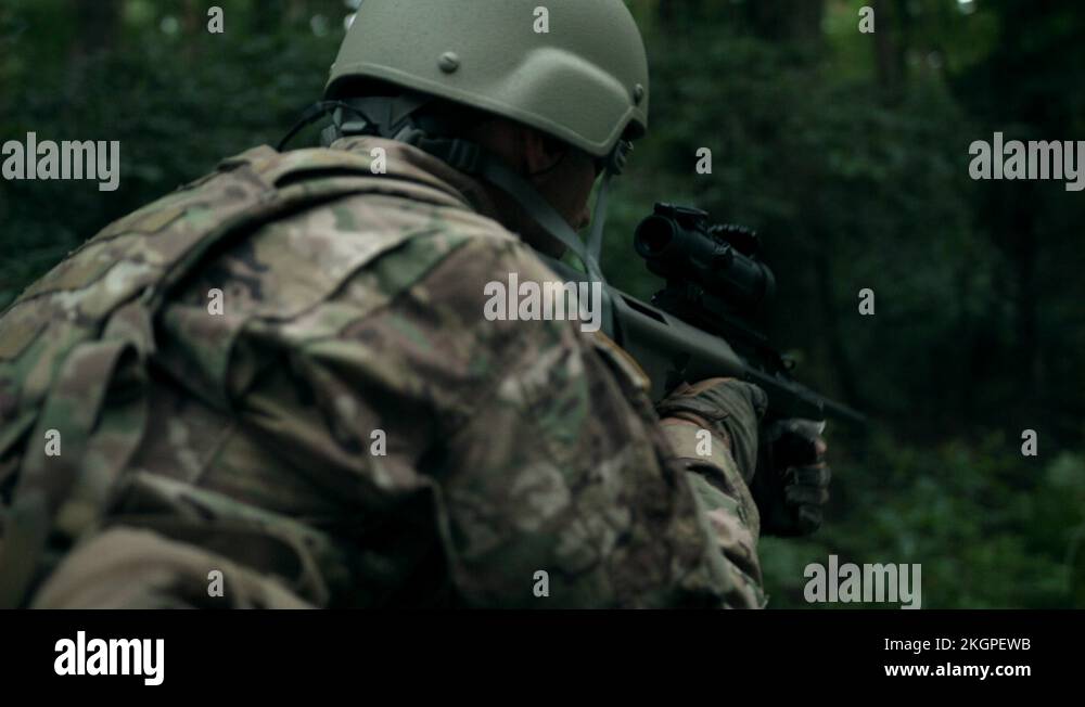 A fully equipped soldier took up a firing position. Fighting. Shooting ...