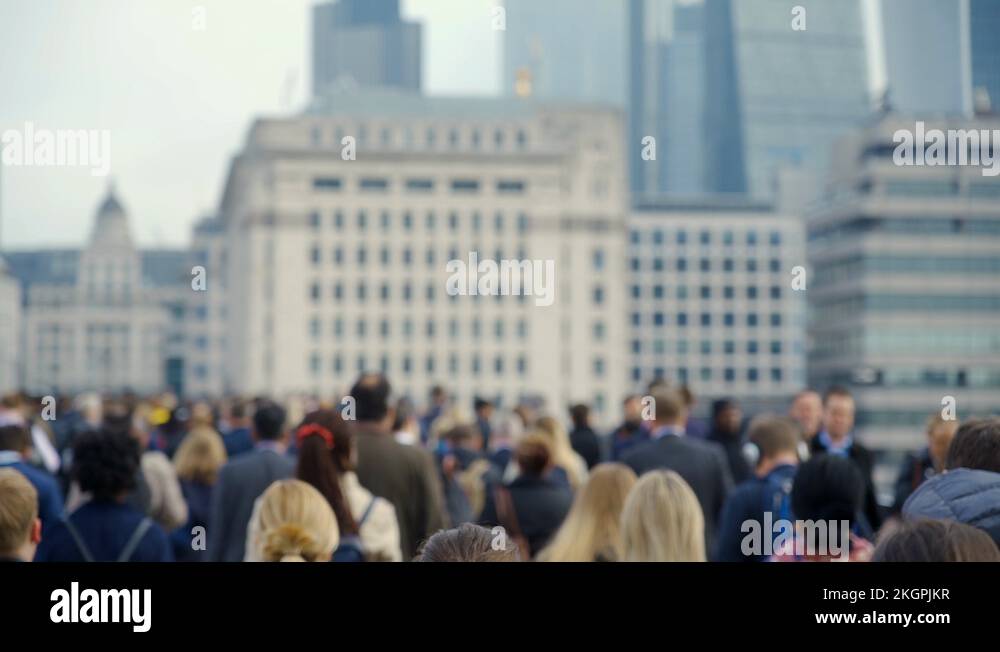 Crowd of commuters, workers, pedestrians. No faces or logos visible ...