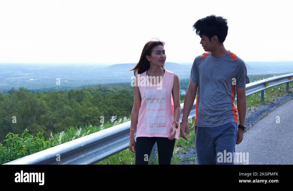 Young Asian couples, walking, talking, looks turbine landscape Stock ...