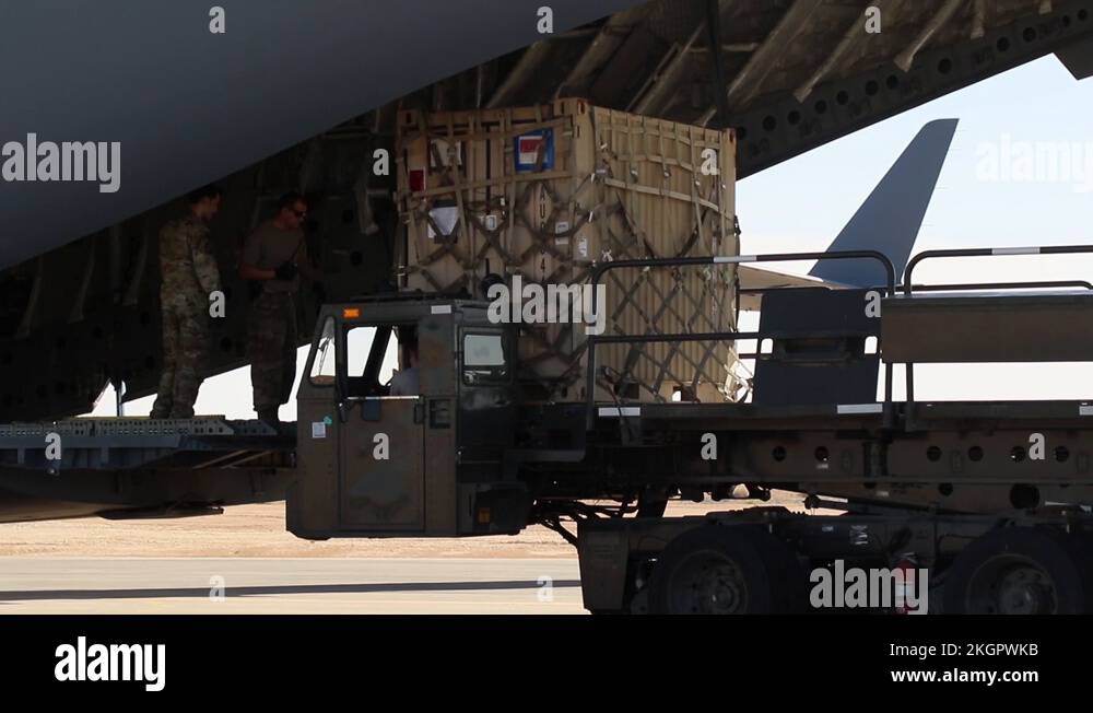Cargo being unloaded onto k-loader from C-17 globemaster Stock Video ...
