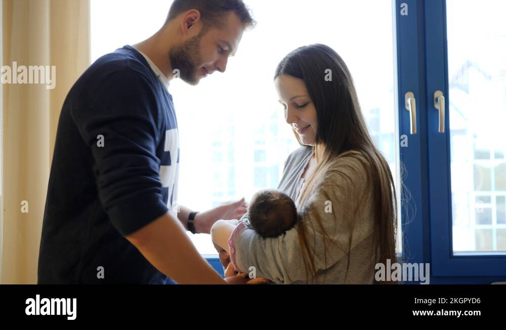 Young father man comes in maternity hospital to hold his newborn baby ...