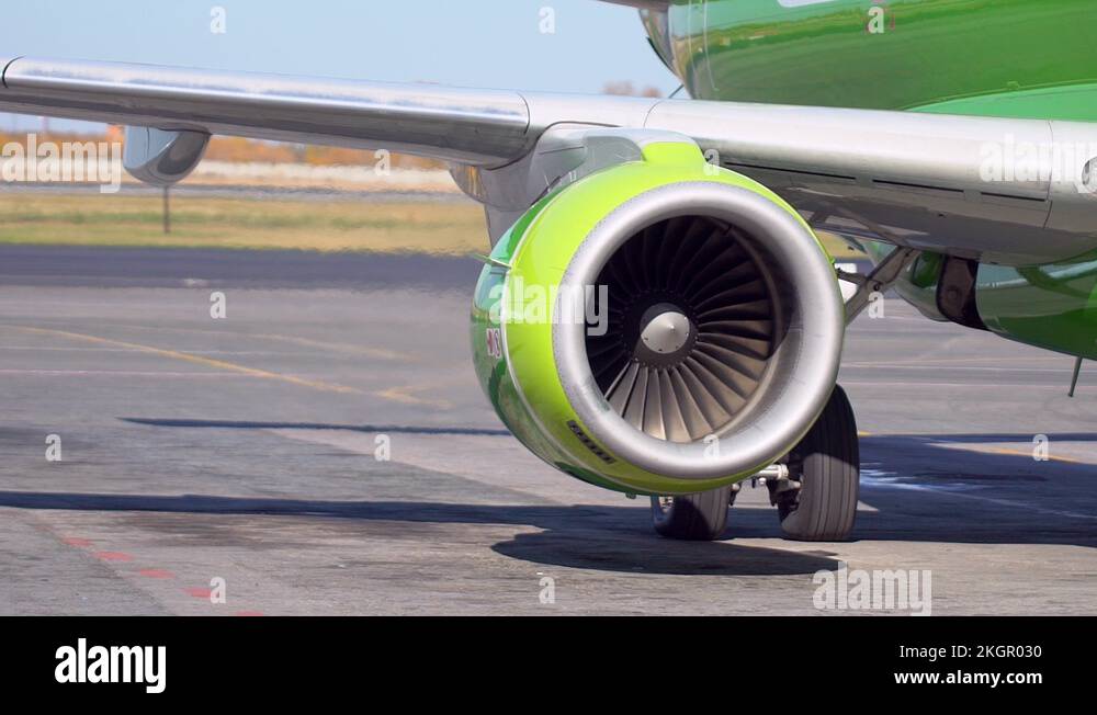 Jet turbine engine of aircraft on runway in airport. Working jet engine ...