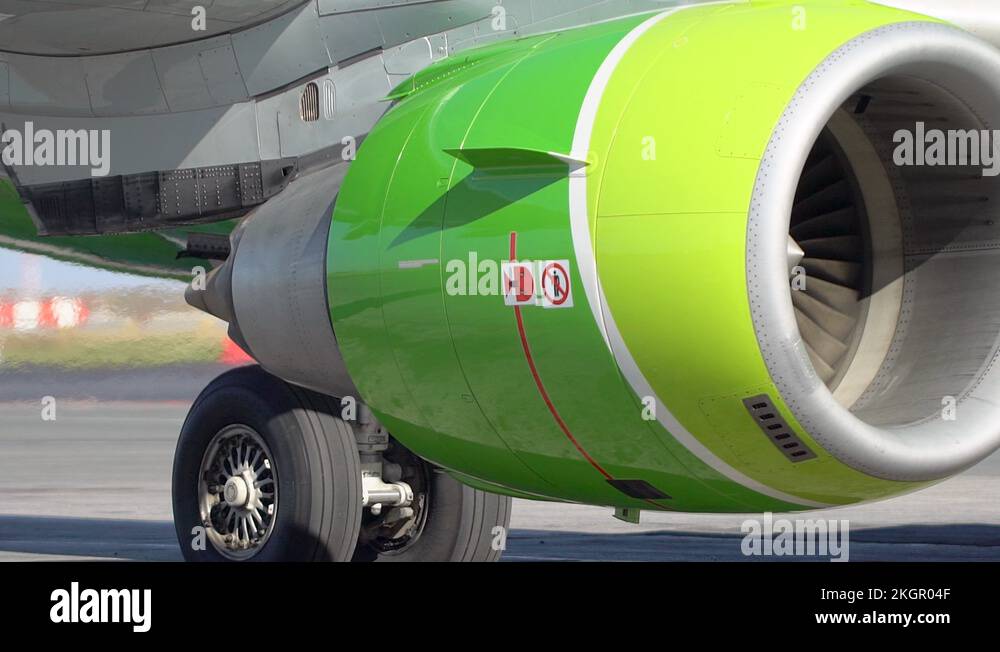 Jet turbine engine of aircraft on runway in airport. Working jet engine ...