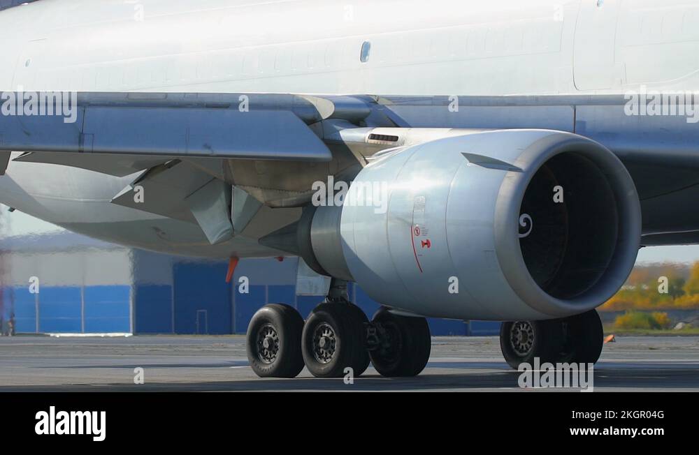 Jet turbine engine of aircraft on runway in airport. Working jet engine ...