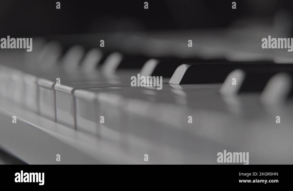 Playing piano keys on MIDI keyboard in home recording studio Stock ...