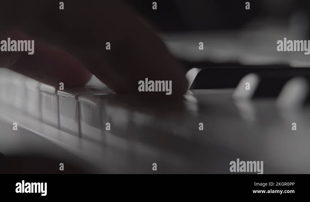 Playing piano keys on MIDI keyboard in home recording studio Stock ...