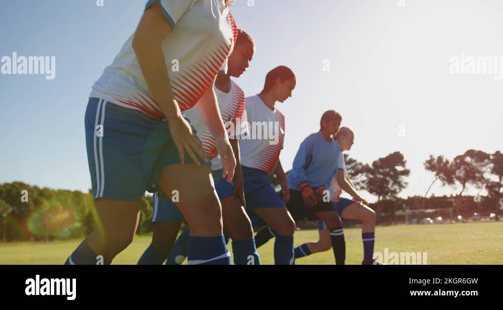 Female soccer players stretching their legs on soccer field. 4k Stock ...