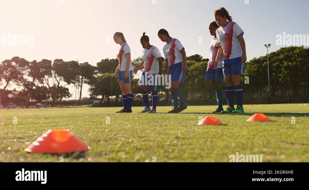 Female soccer players stretching their legs on soccer field. 4k Stock ...