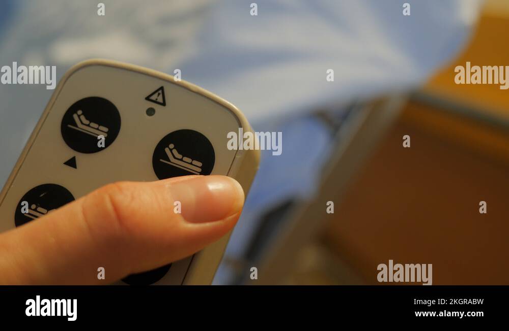 Pushing down the button patient using hospital automatic electric bed ...
