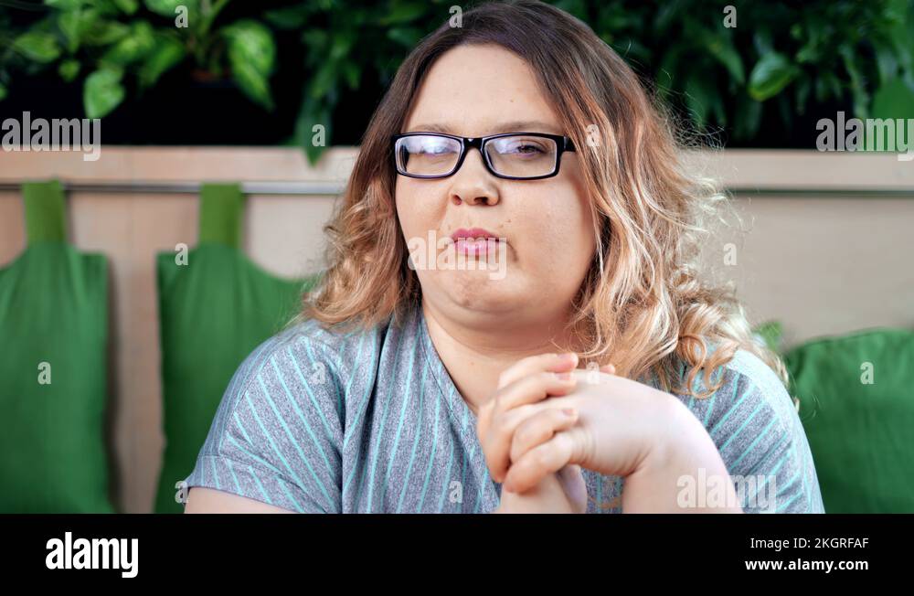 Close-up portrait of confident beautiful chewing meal fat woman posing ...