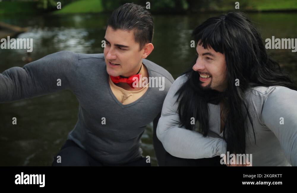 Funny active guys in fake body muscle costumes dance and sing on ...