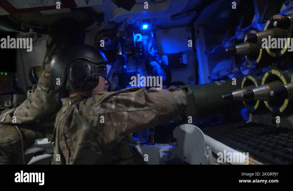 Soldier removing ammunition from shells inside self propelled Howitzer ...