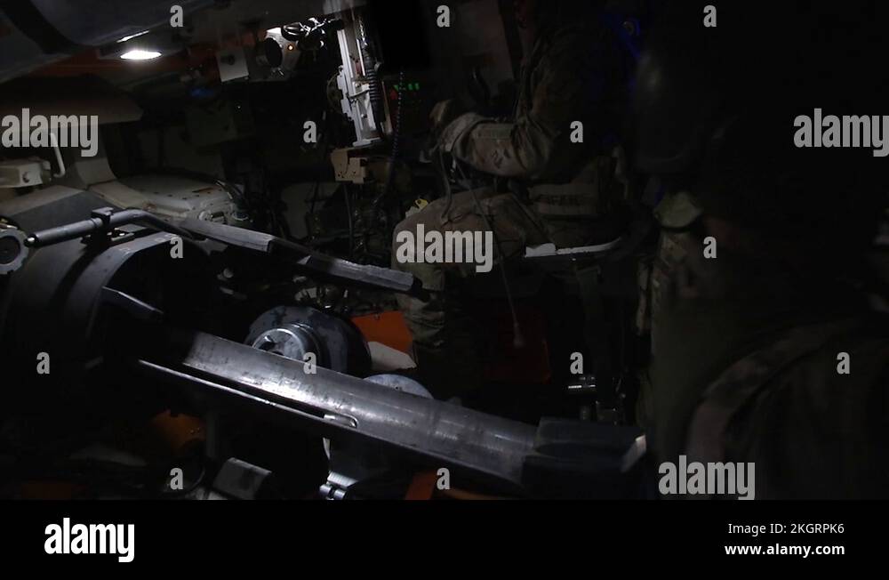 Inside self-propelled Howitzer as soldiers load and fire cannon Stock ...
