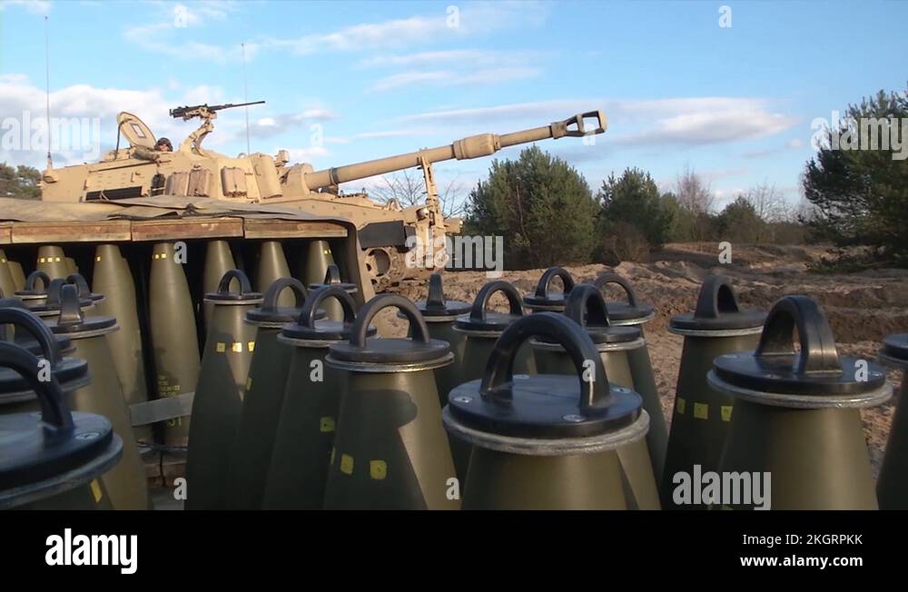 Self-propelled Howitzer travelling past artillery shells Stock Video ...